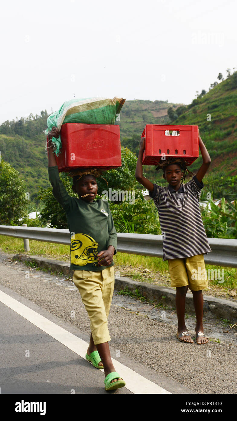 Rwandan boys walking back from the market in rural Rwanda Stock Photo ...
