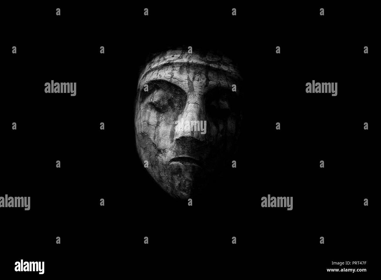scary stone face isolated on black background Stock Photo - Alamy