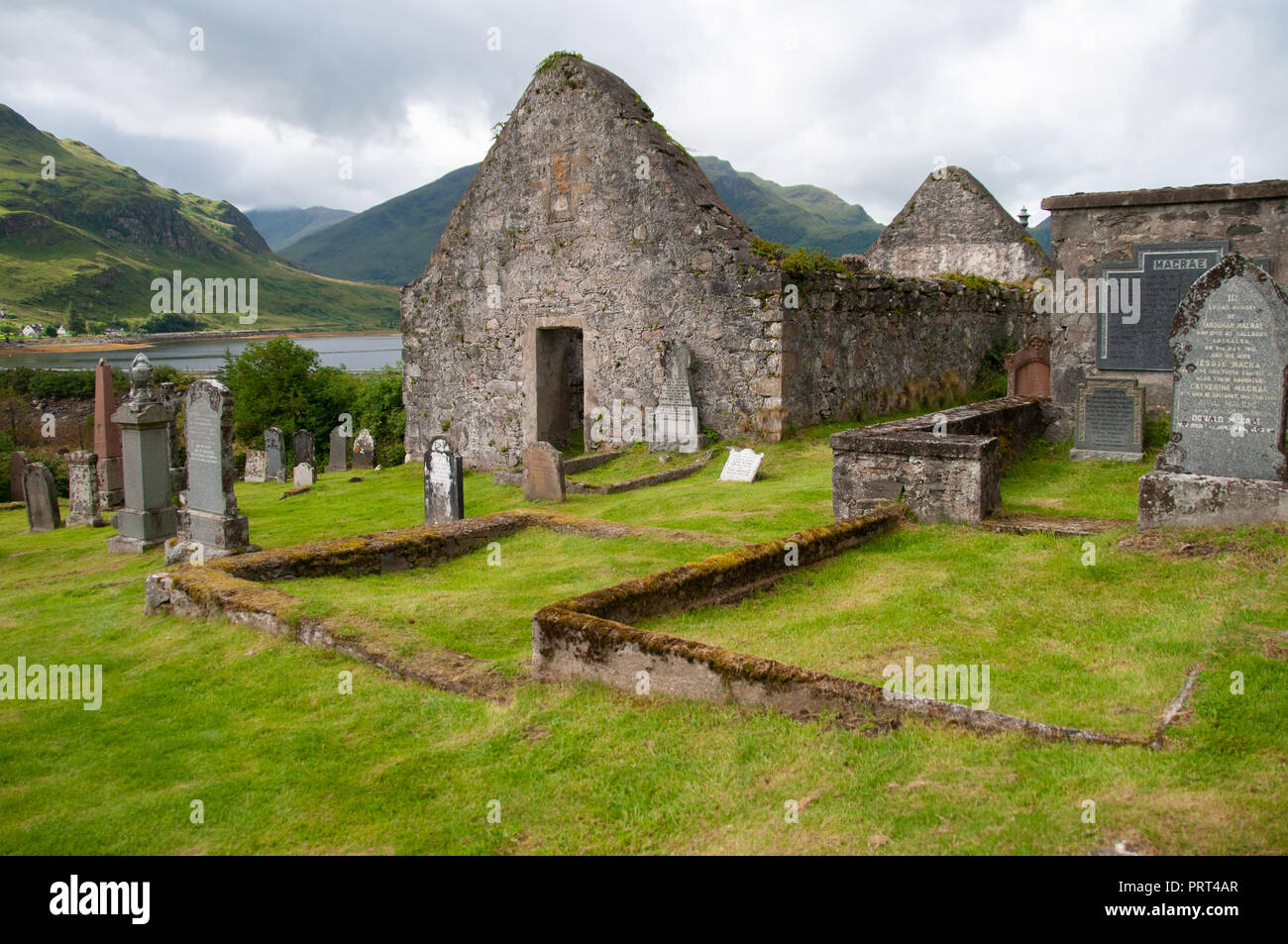 Crumbling stone ruins of barns, stone walls and old gravestones on a ...