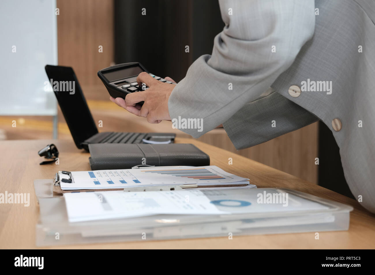 financial adviser working with calculator at office. accountant doing ...