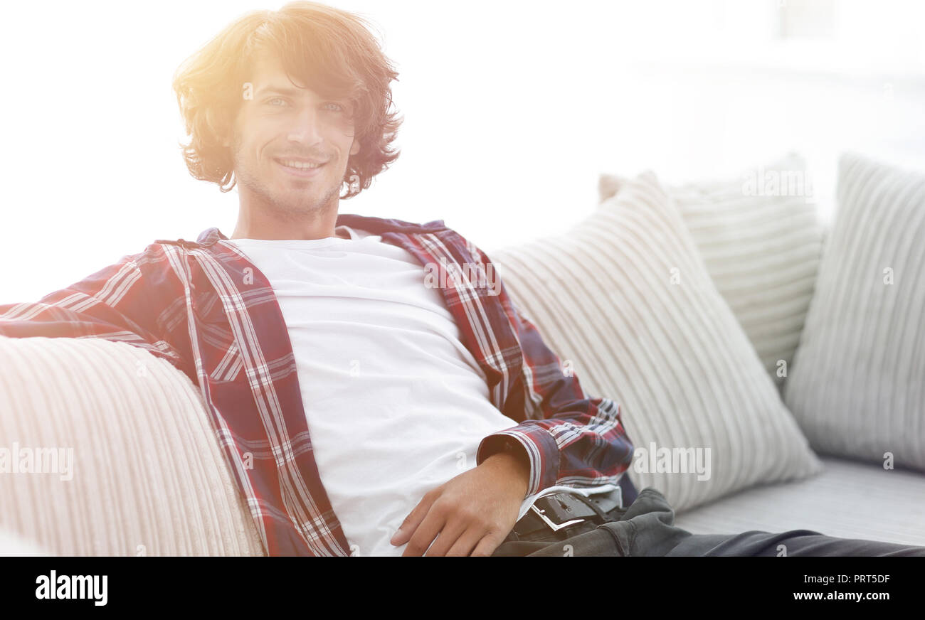 handsome successful guy resting on the couch Stock Photo - Alamy