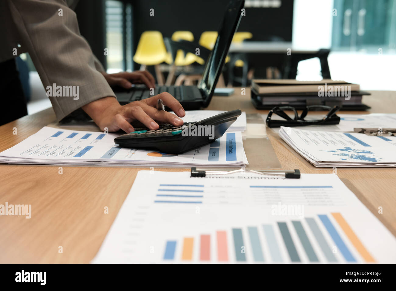 financial adviser working with calculator, business document & computer ...