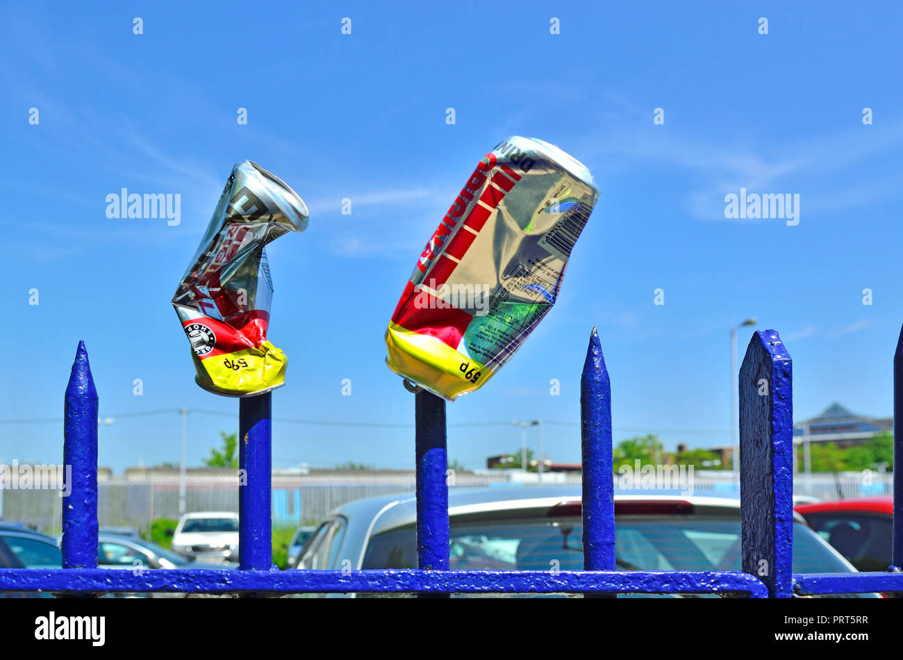 Tin drinks cans stuck on spikes of car park railing, Maidstone, Kent ...