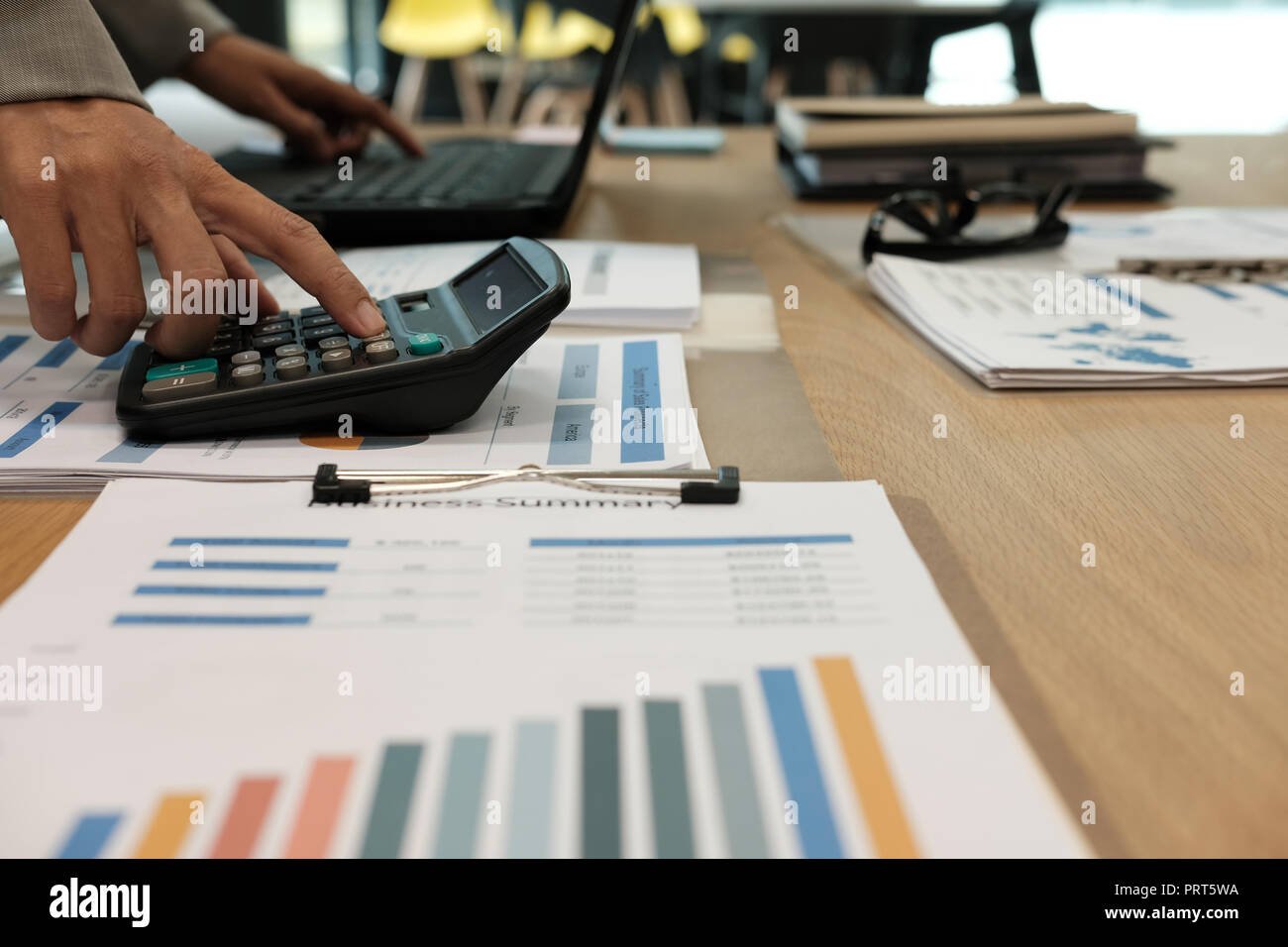 financial adviser working with calculator, business document & computer ...