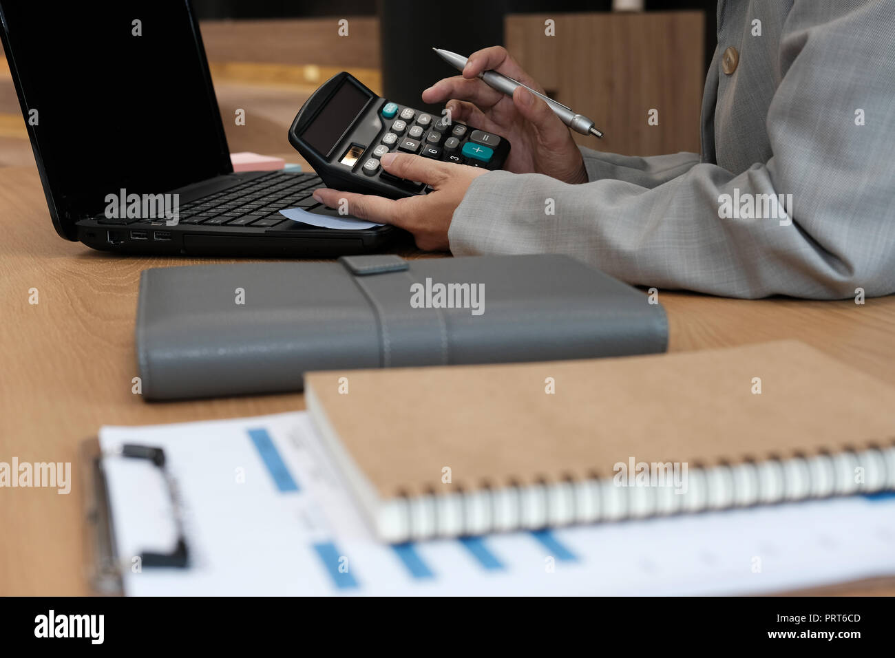 financial adviser working with calculator at office. accountant doing ...