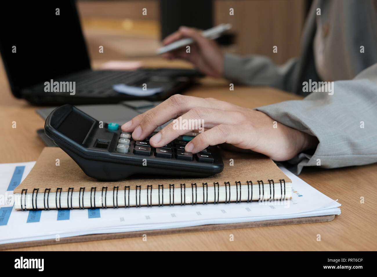 financial adviser working with calculator at office. accountant doing ...