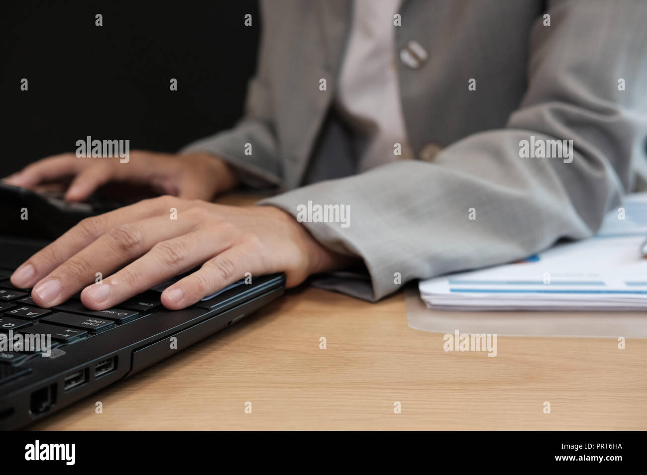 financial adviser working with calculator & computer at office ...