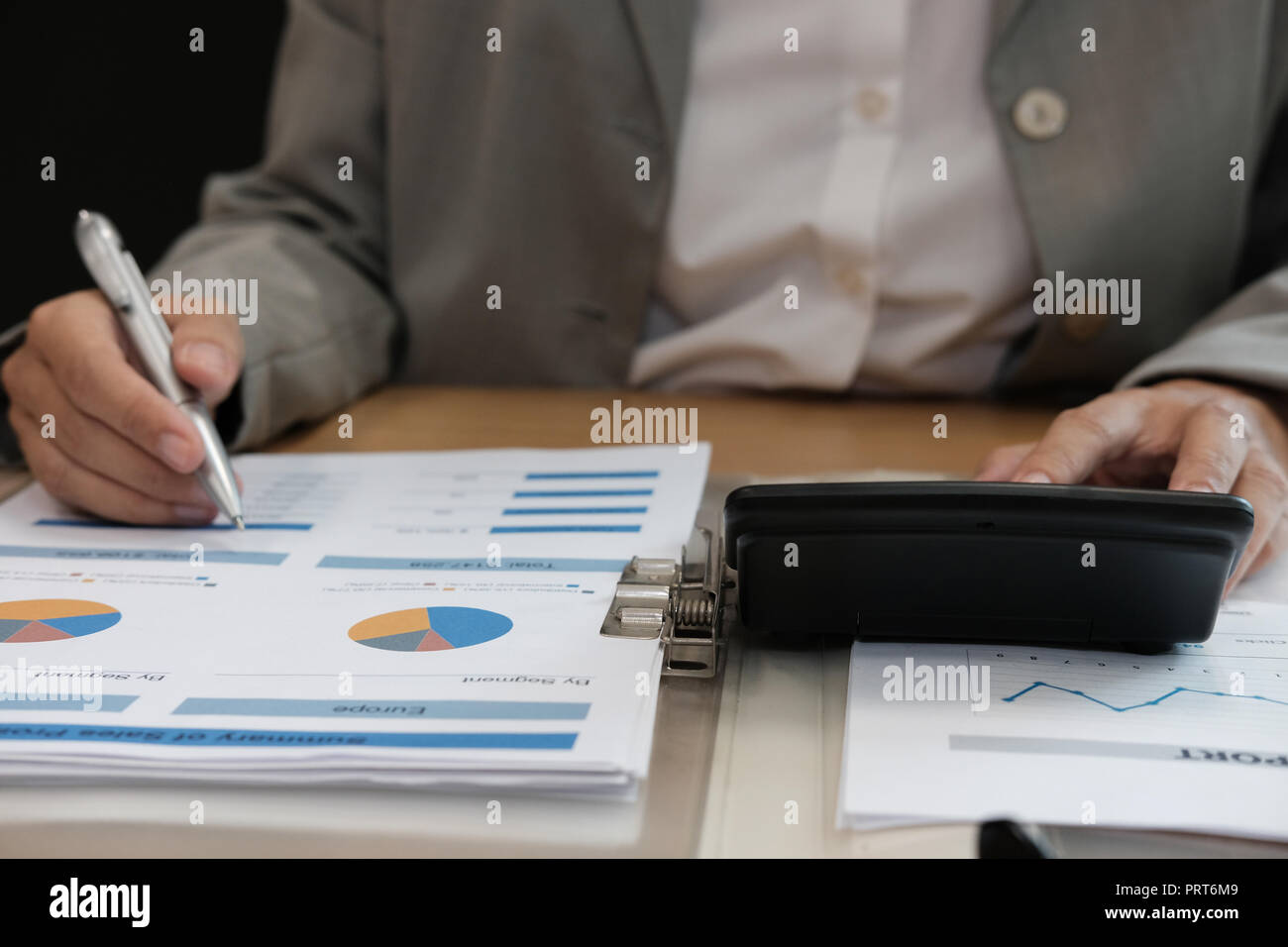 financial adviser working with calculator, business document at office ...