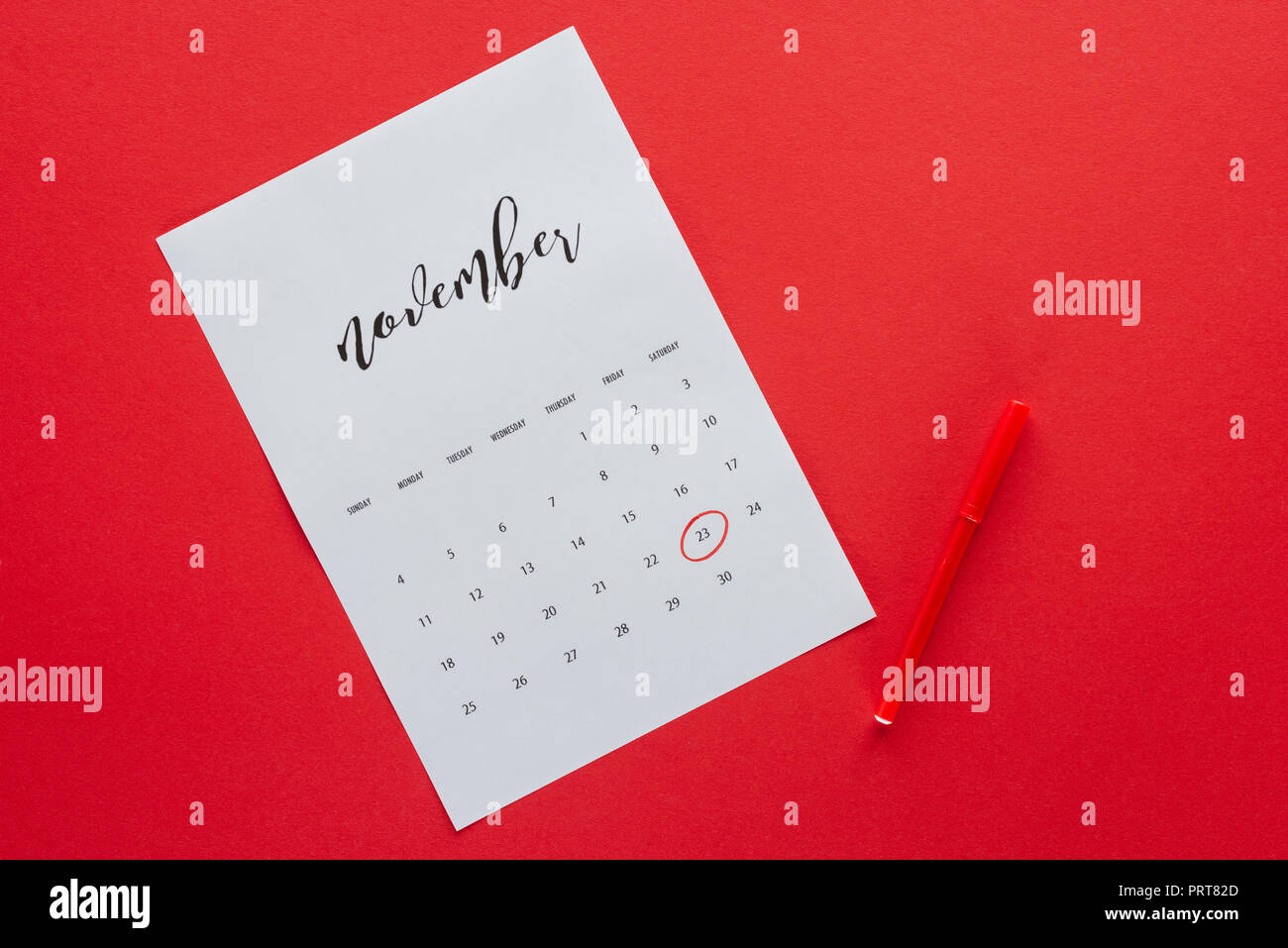 top view of calendar for November with marker isolated on red, black ...