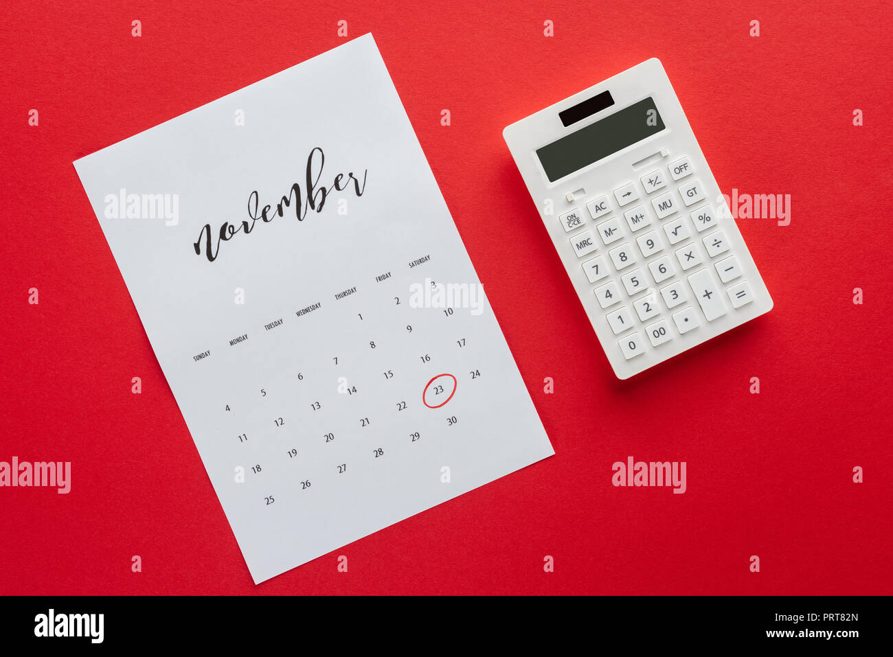 top view of calendar for November and calculator isolated on red, black ...