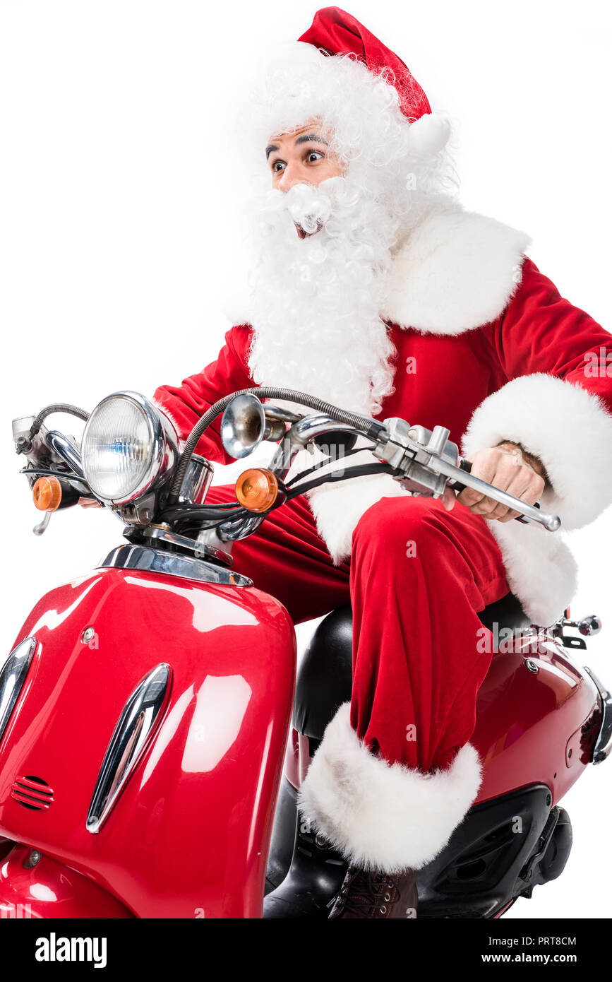 surprised santa claus in costume riding on scooter isolated on white ...