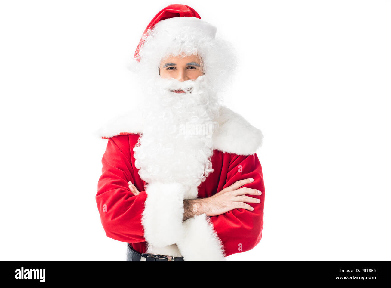 smiling santa claus in traditional costume standing with crossed arms ...