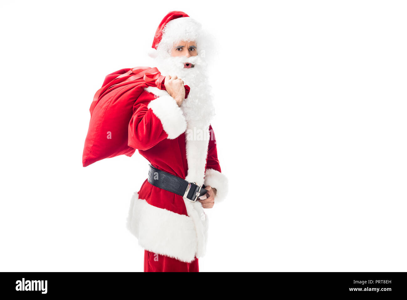 shocked santa claus holding christmas sack over shoulder isolated on ...