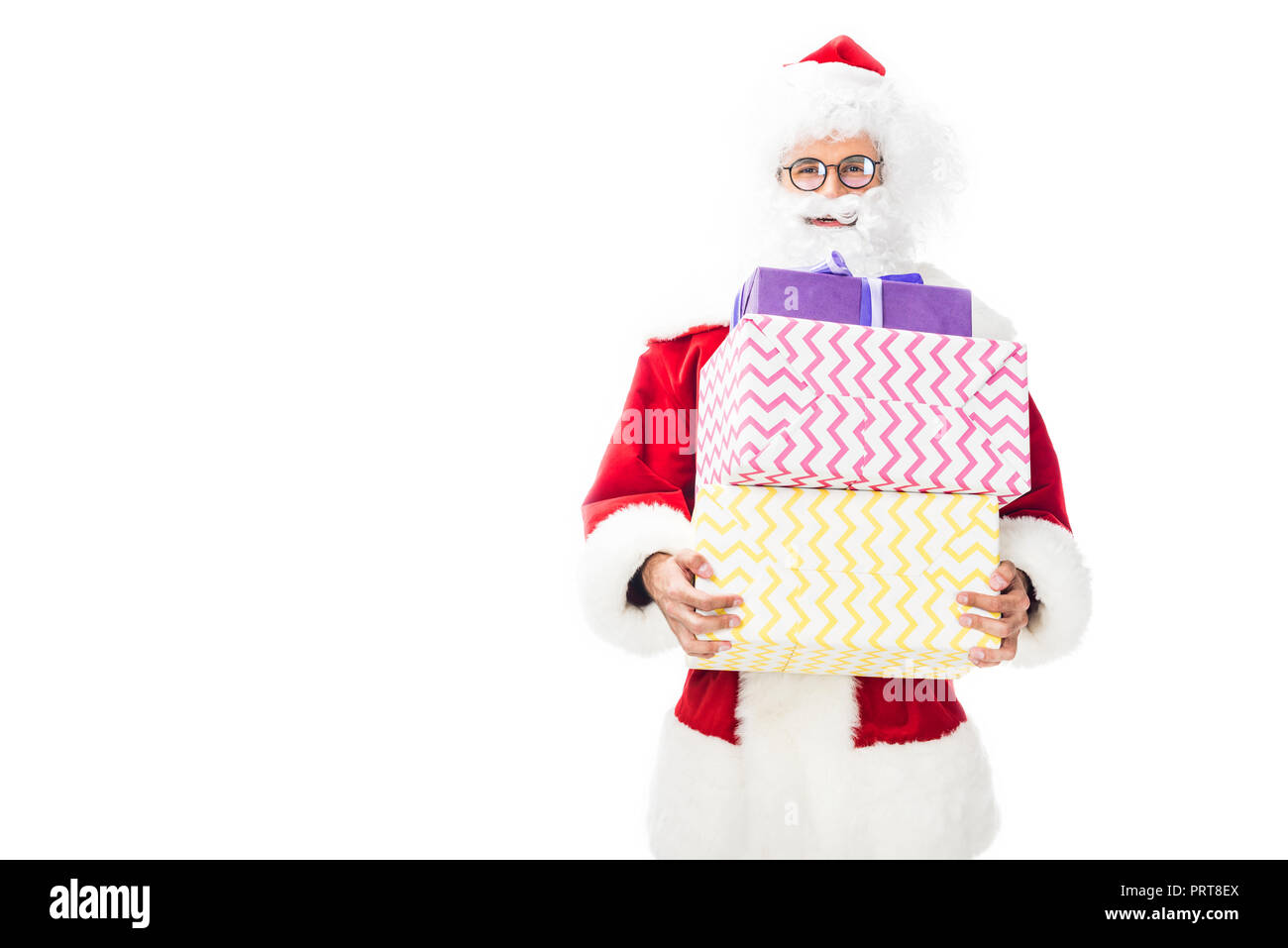 happy santa claus in eyeglasses holding pile of christmas presents ...