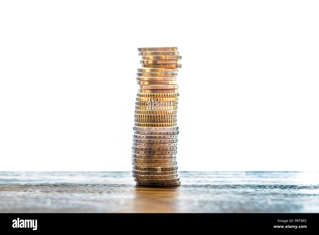 stack of euro coins on table against white background Stock Photo - Alamy