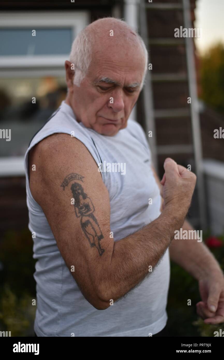 Middle aged men showing off with tattoos Stock Photo - Alamy