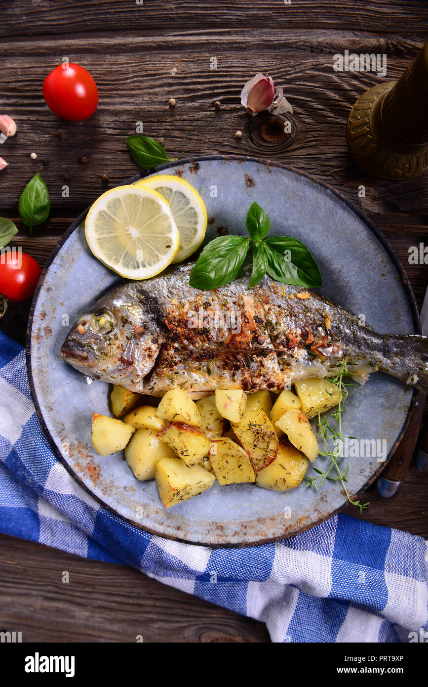 Fried bream fish with potatoes Stock Photo - Alamy