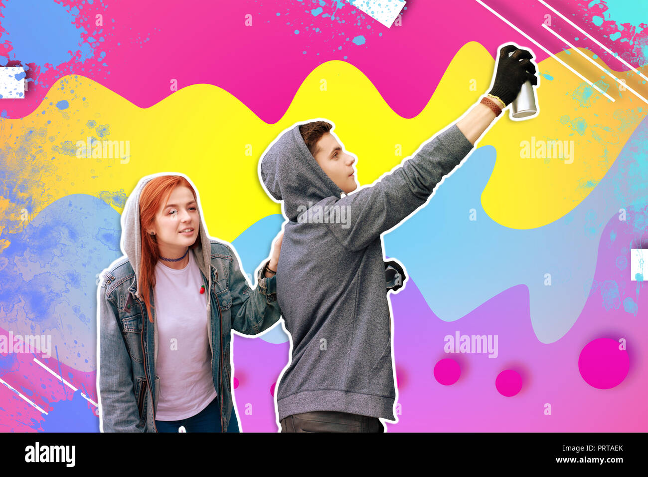 Alert girl looking into the distance and her friend drawing graffiti ...