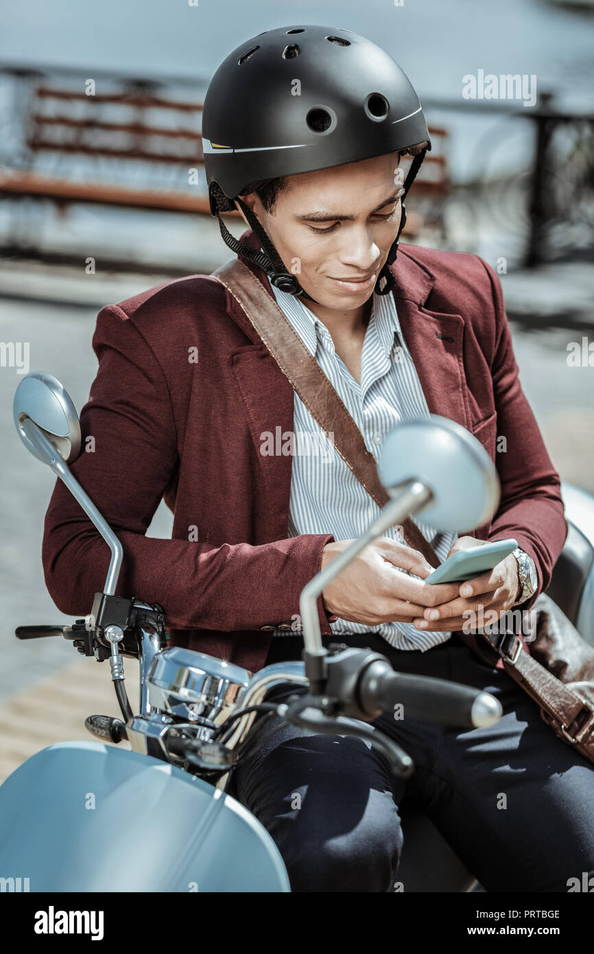 Meditative thoughtful guy filling address on phone Stock Photo - Alamy