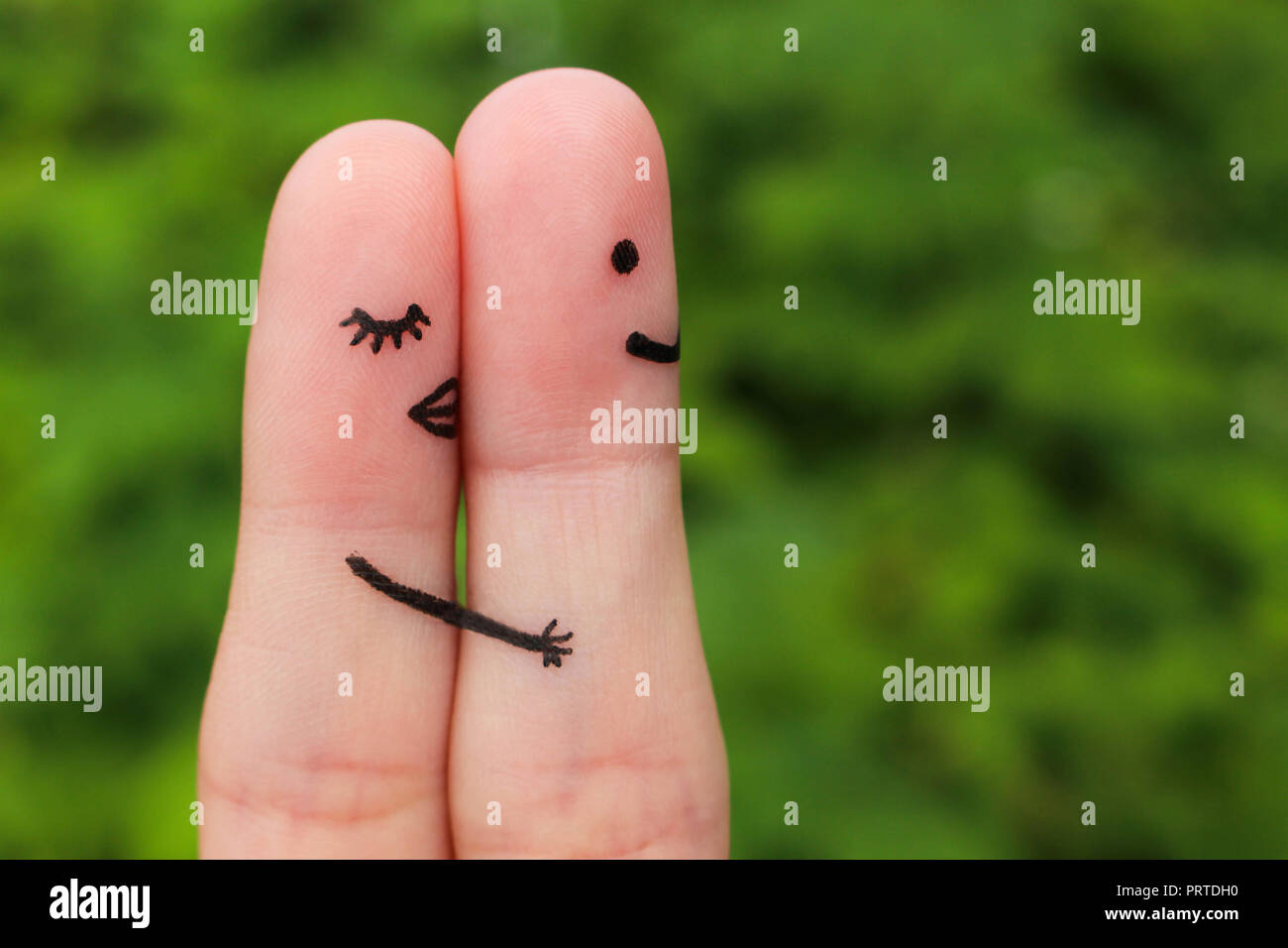 Finger art of a Happy couple. Girl a hug and kisses the boy Stock Photo ...