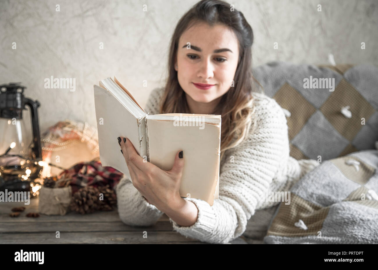 cozy composition of young beautiful girl reading a book ,the concept of ...