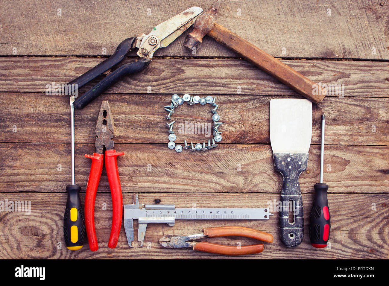 Construction tools in the form of house on wooden background Stock ...