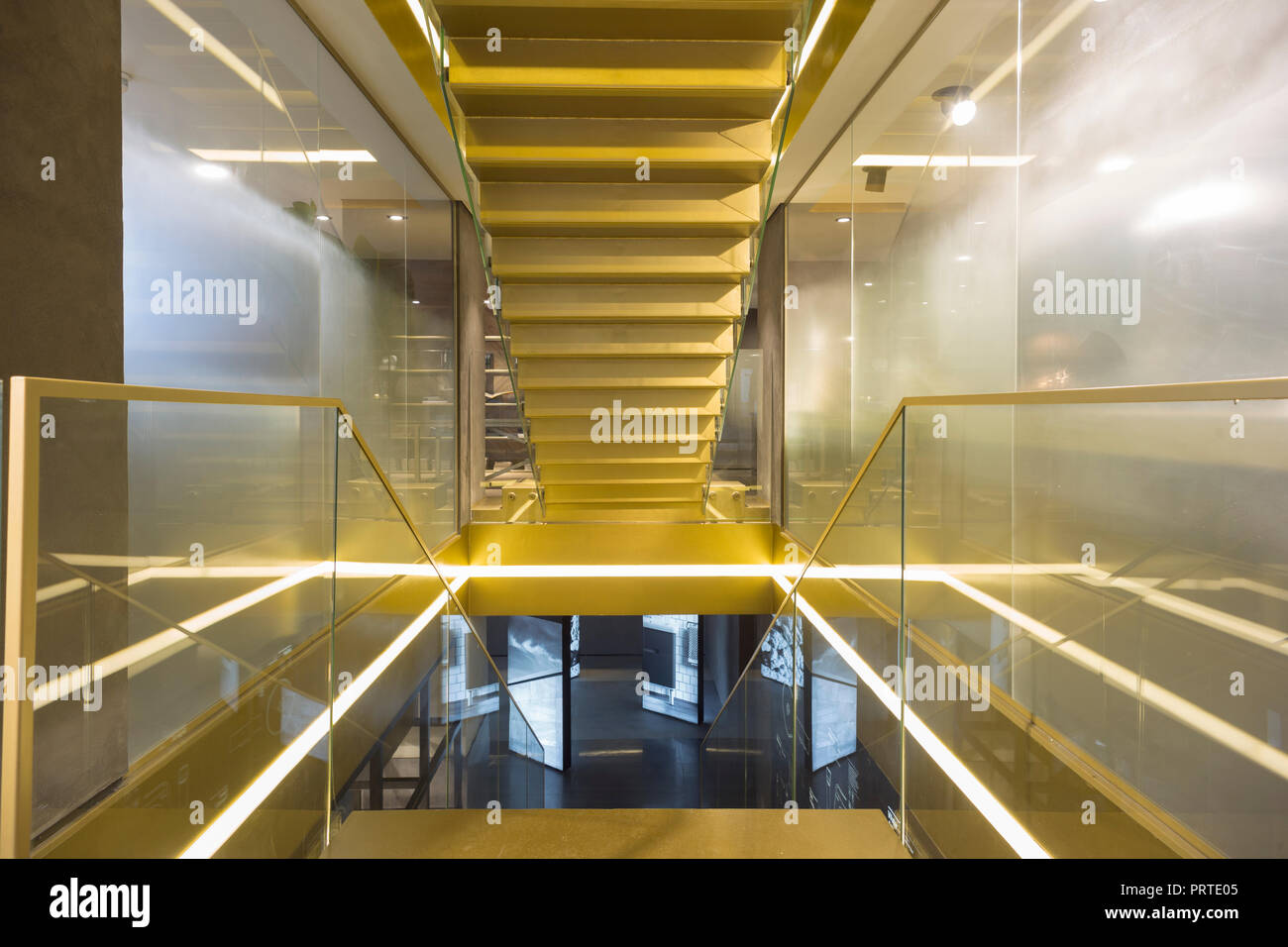 Golden staircase in a wide store Stock Photo - Alamy