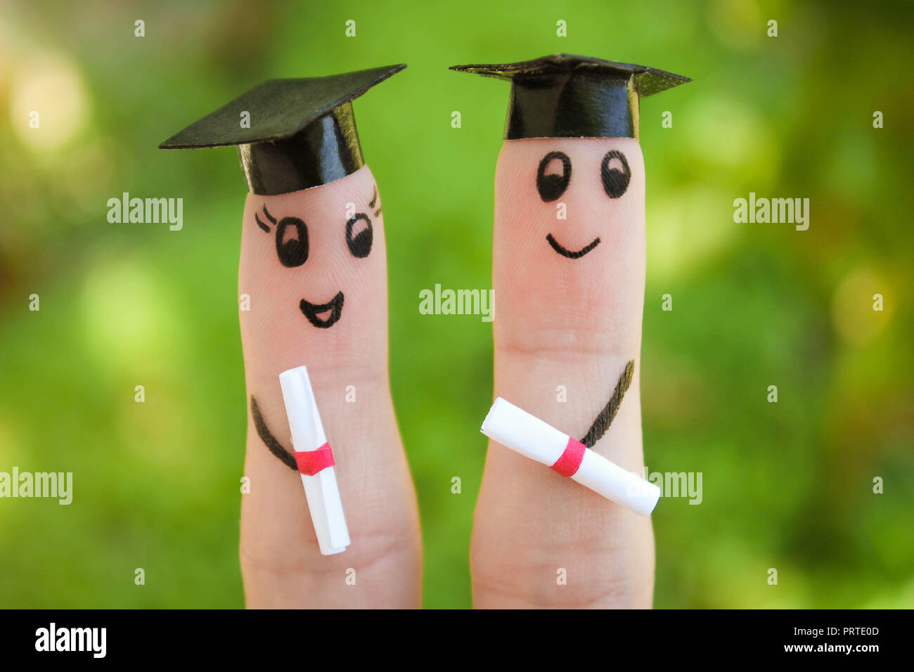 Face painted on the fingers. students holding their diploma Stock Photo ...