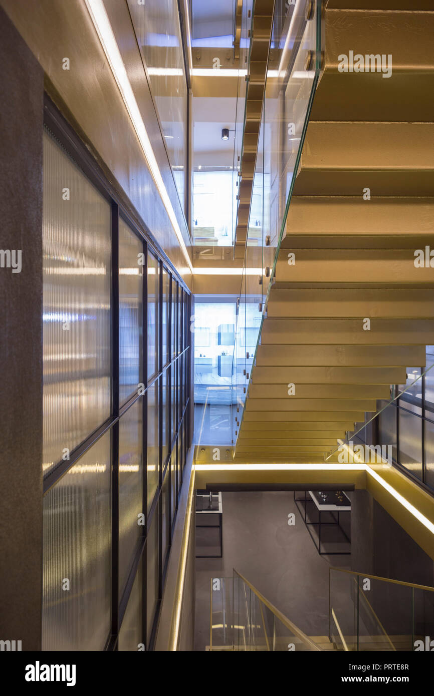 Golden staircase in a wide store Stock Photo - Alamy
