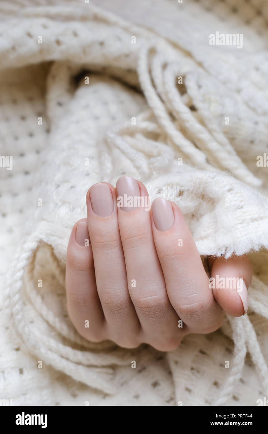 Beautiful female hand with beige nail design Stock Photo - Alamy