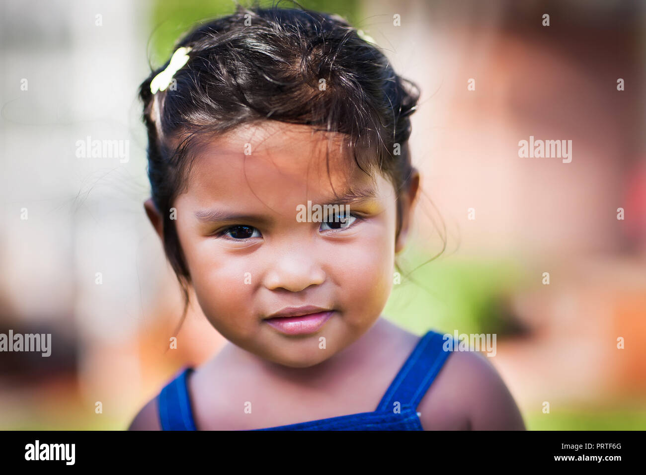 Cute little girl with thoughtful look and subtle smile Stock Photo - Alamy
