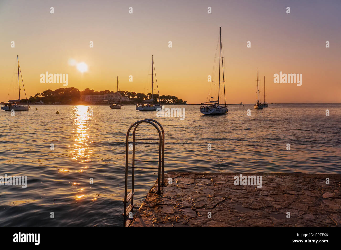 Beautiful sunset views and sailing boats next to the floating swimming ...