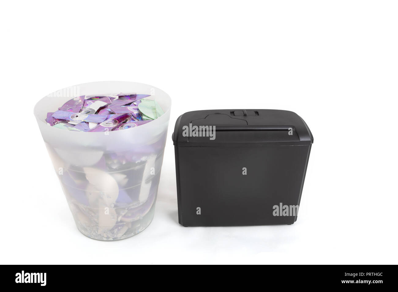 trash with stripes of shredded CD and DVD data disc destroyed by ...