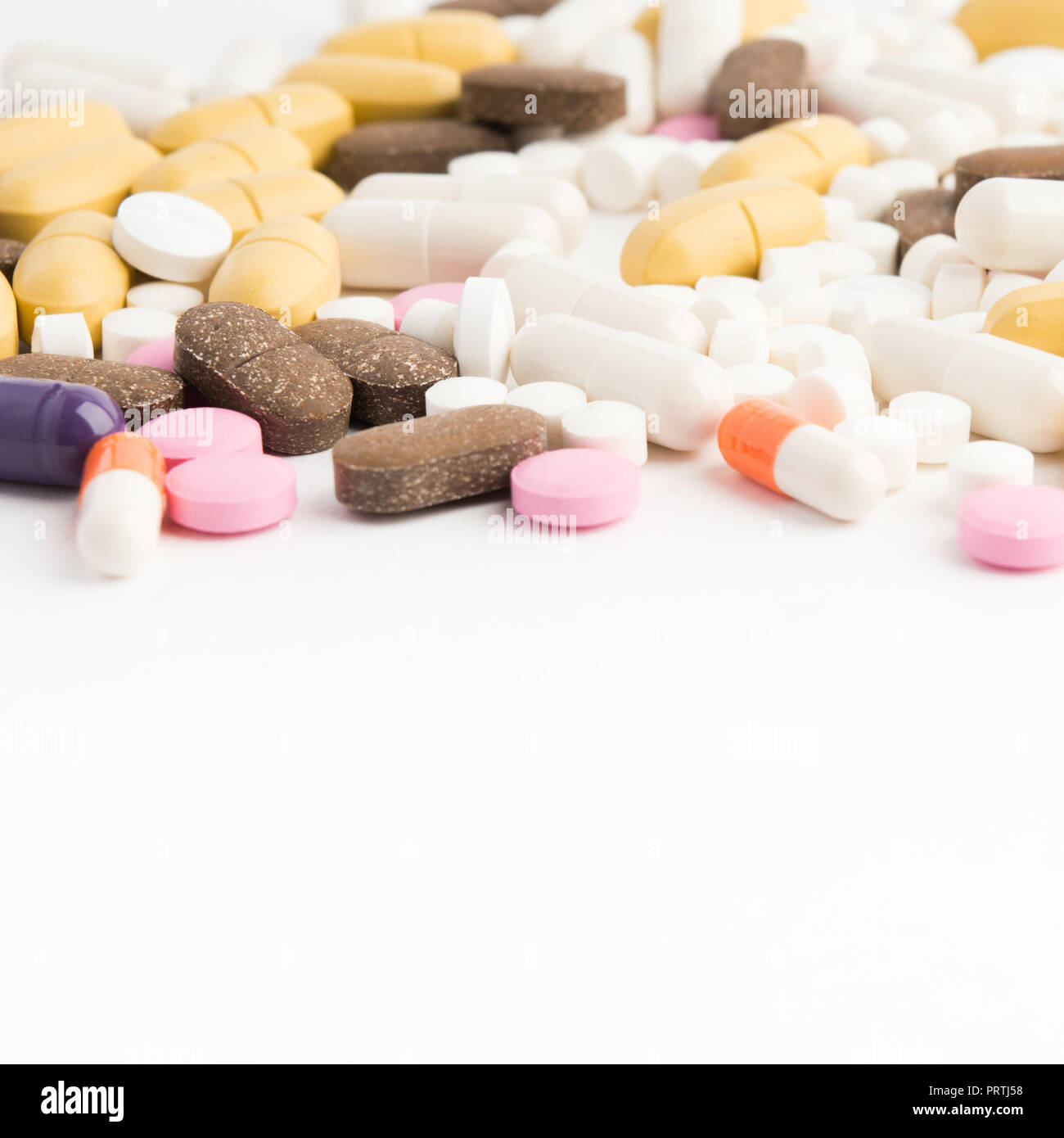 Different colorful tablets, pharmacy concept with copy space over white ...