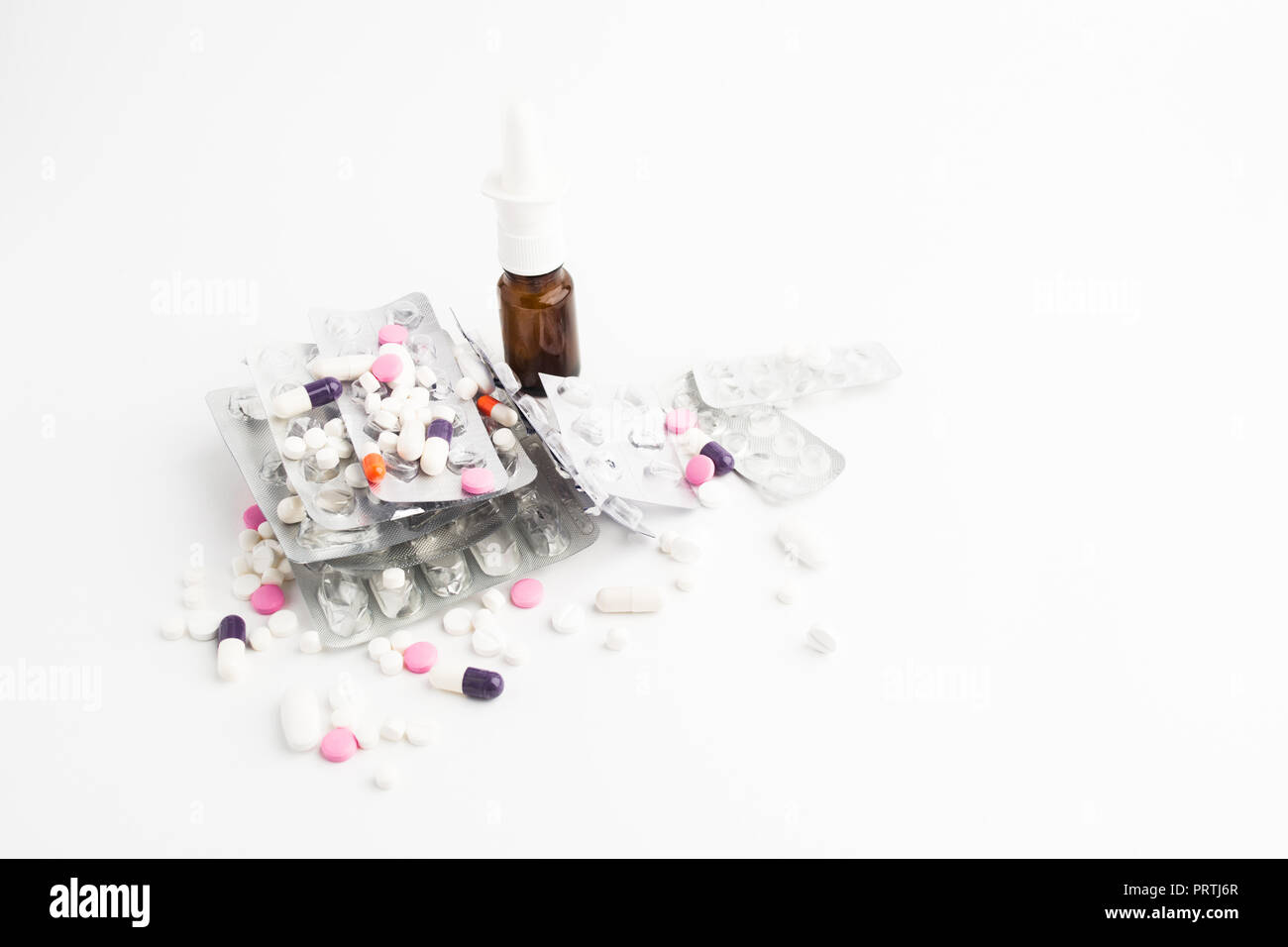 Various drugs and pills with spray for illness on white background ...