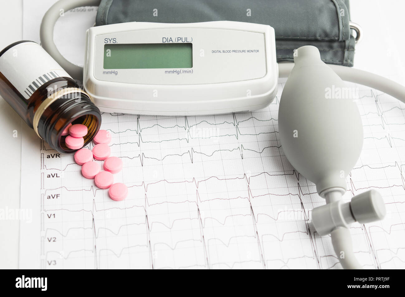 Equipment for blood pressure with pink pills on cardiogram with copy ...
