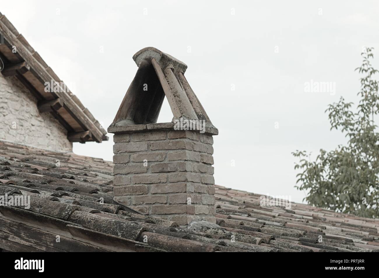 Isolated chimney on the roof of an ancient house (Marche, Italy, Europe ...