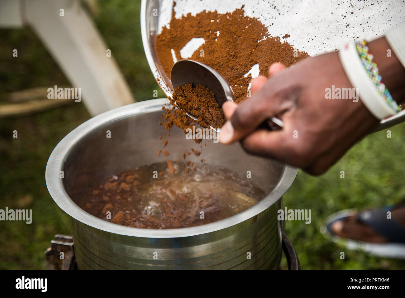 Fresh coffee powder thrown in hot boiling water with spoon Stock Photo ...