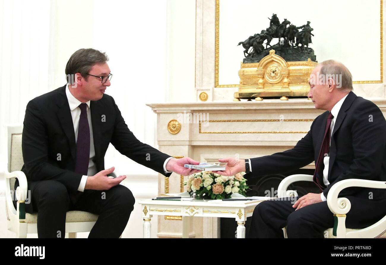 Serbian President Aleksandar Vucic, left, presents a book to Russian ...
