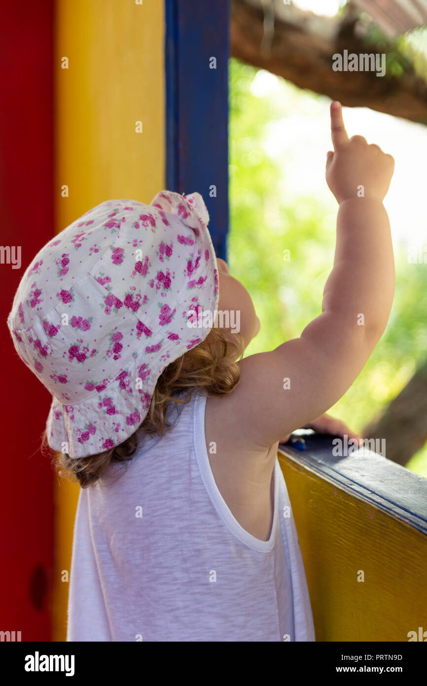 Little baby girl playing in a tree-house Stock Photo - Alamy