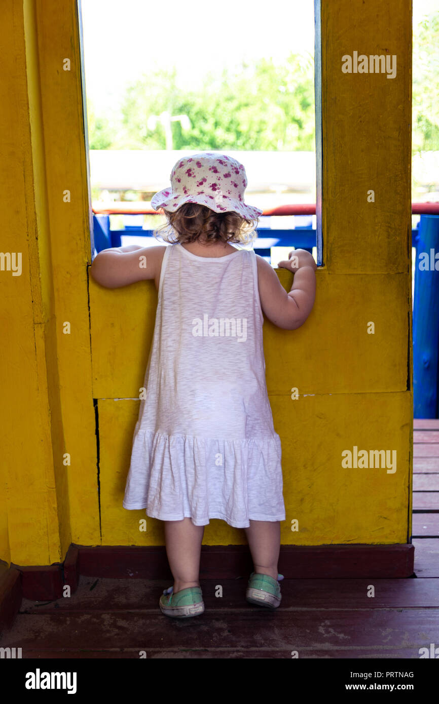 Little baby girl playing in a tree-house Stock Photo - Alamy
