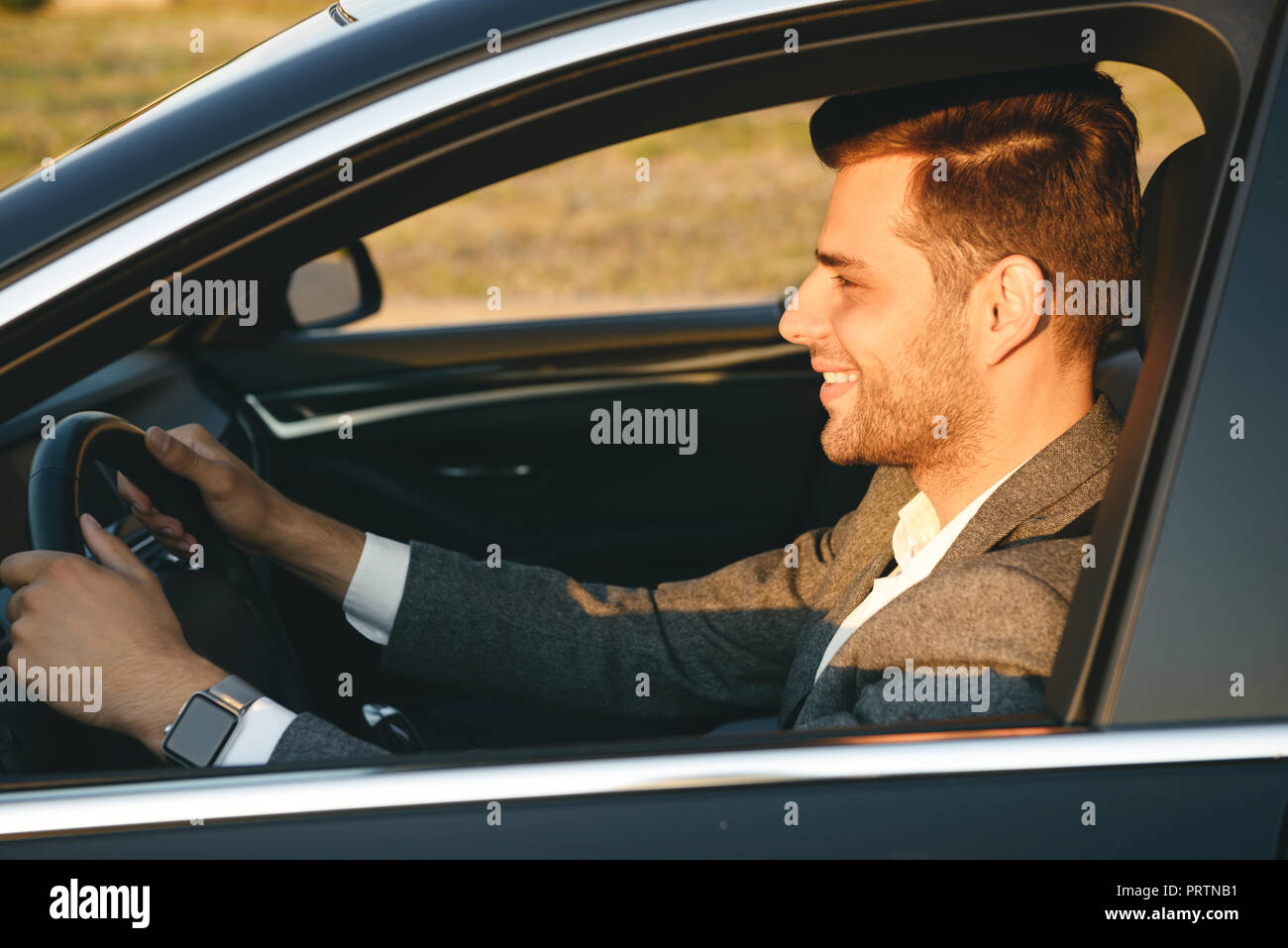 Happy bussinesman in suit driving his car Stock Photo - Alamy