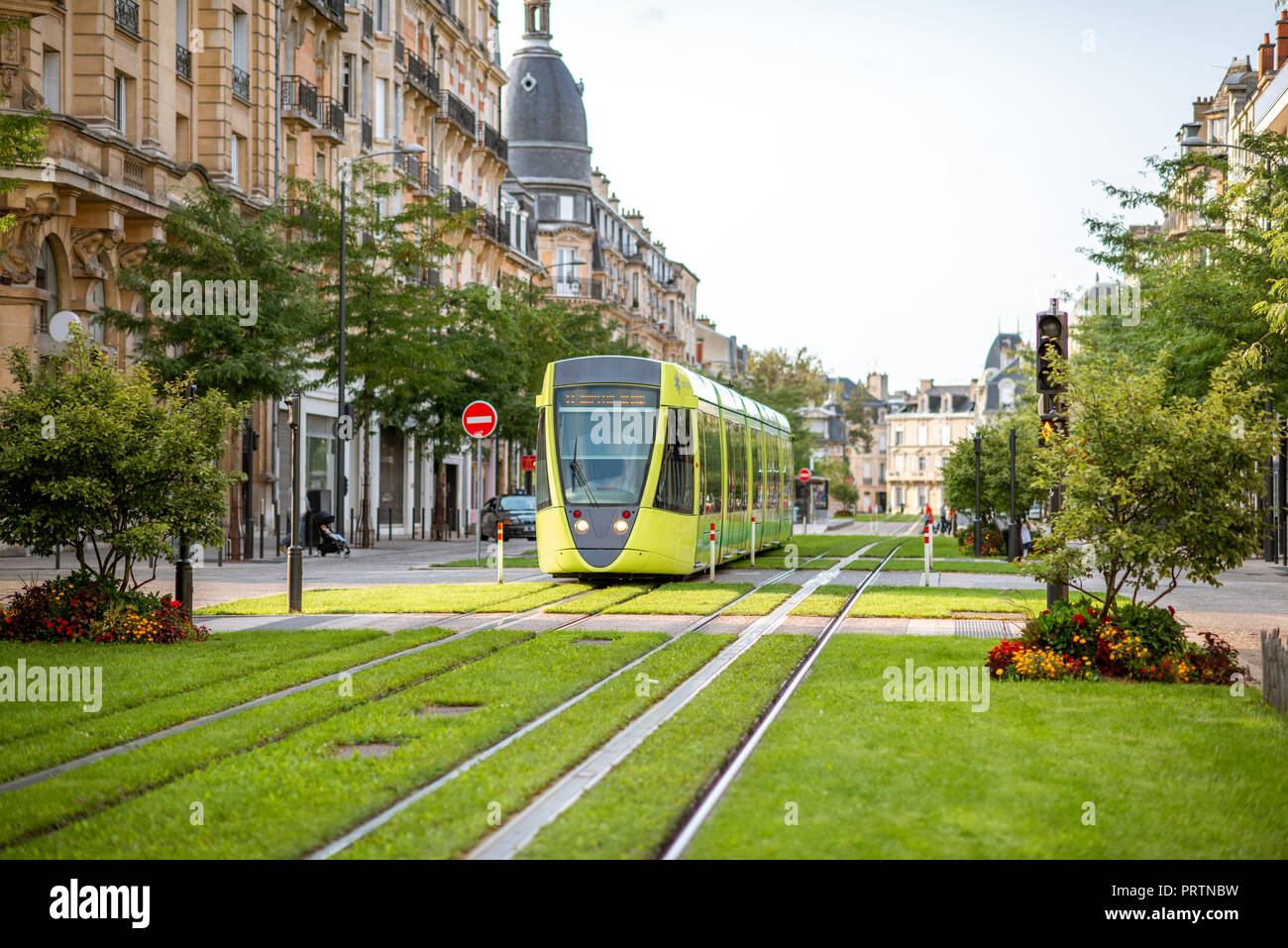 Street view with green railway of public transport in Reims city in ...