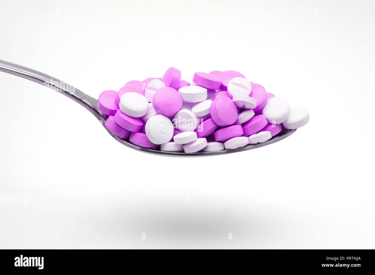 spoon with tablets isolated on white backgrouond Stock Photo - Alamy