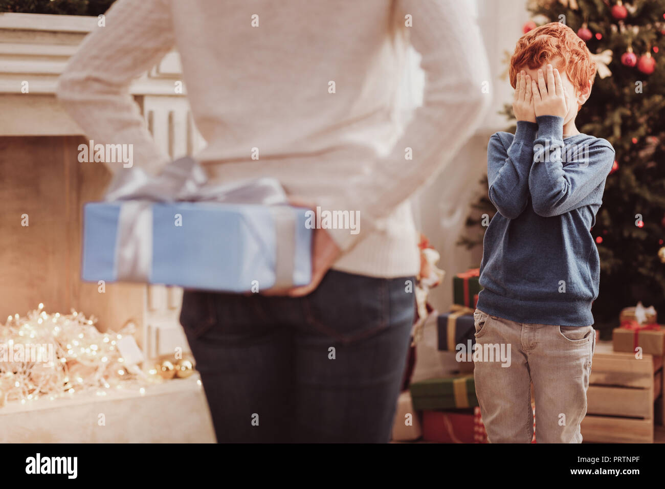 Little boy waiting for his present Stock Photo - Alamy