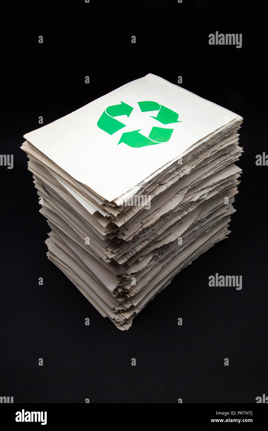 stack of documents for recycling on a black background Stock Photo - Alamy