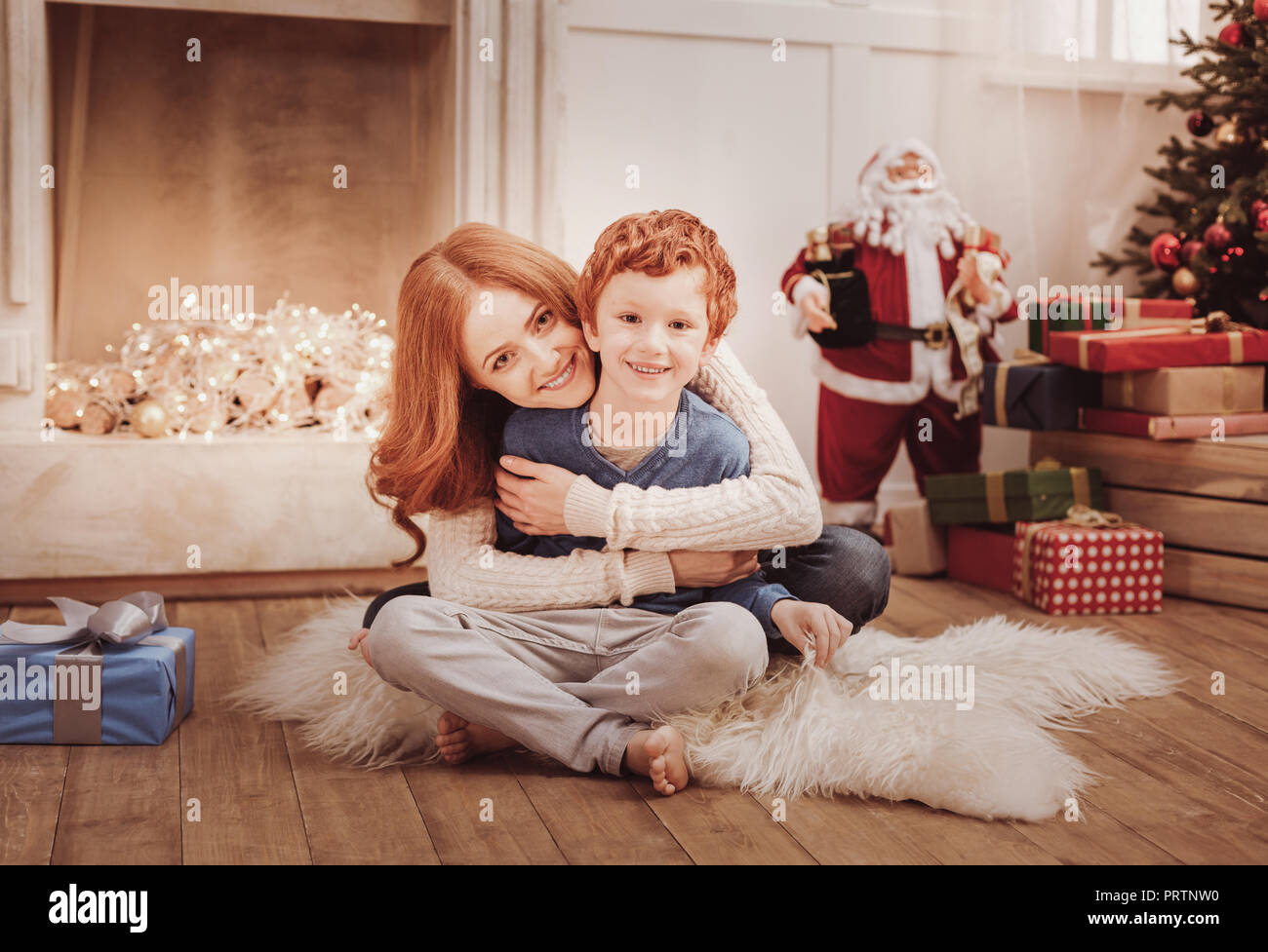 Full length of adorable family sitting on the floor Stock Photo - Alamy
