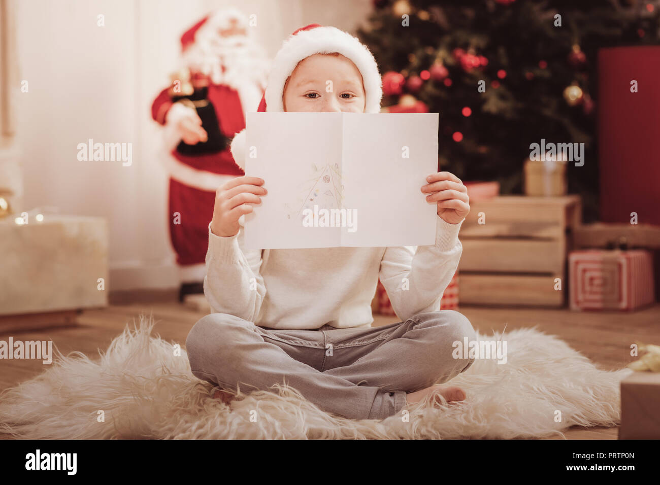 Full length of pleasant child with a drawing Stock Photo - Alamy