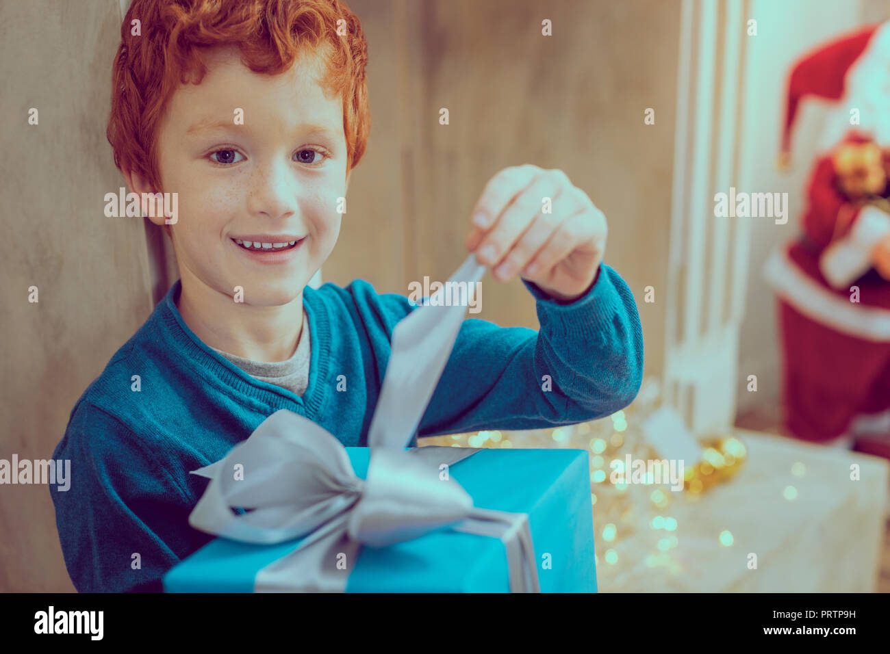 Kid opening present hi-res stock photography and images - Alamy