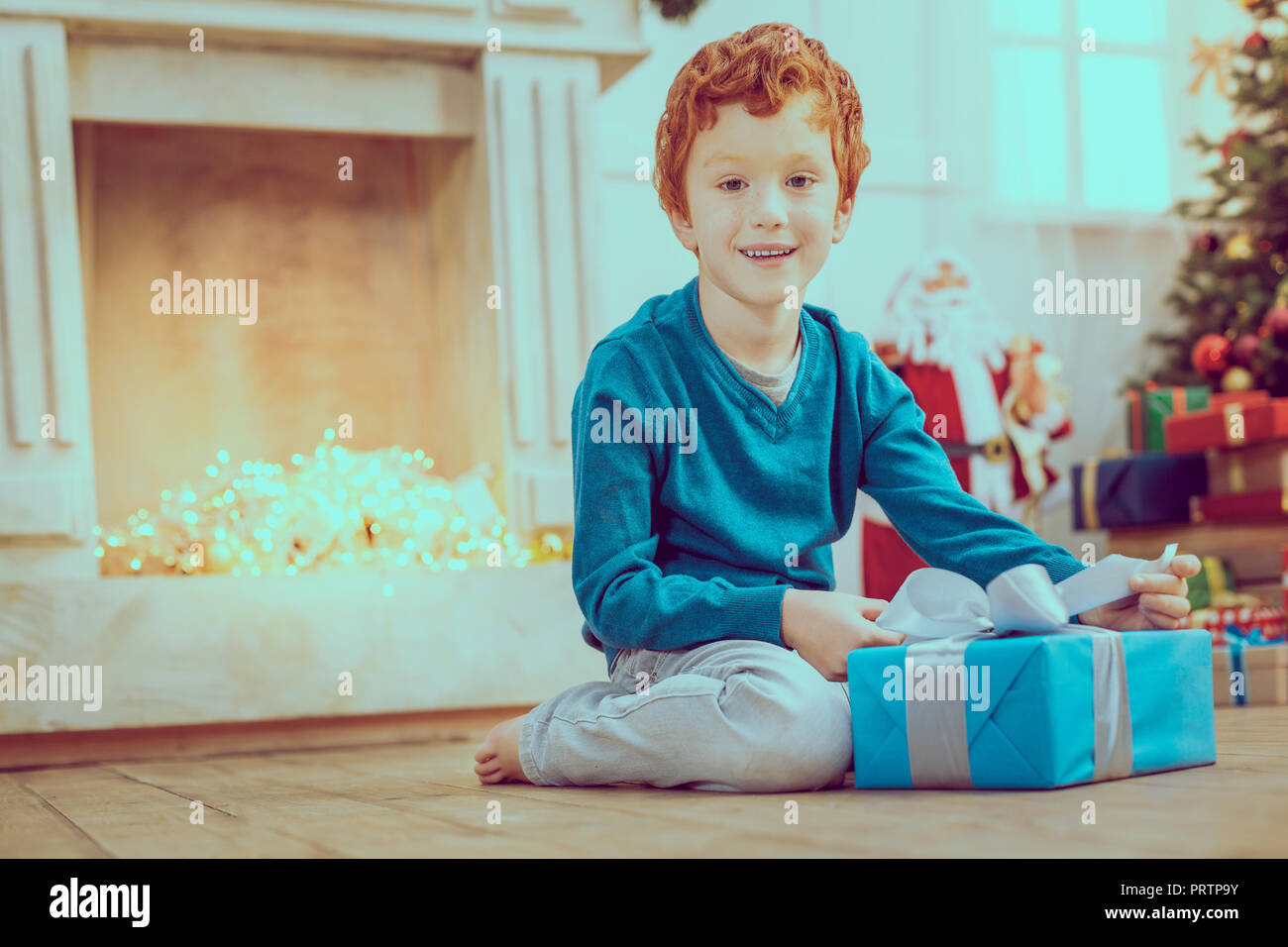 Happy child sitting near his present Stock Photo - Alamy